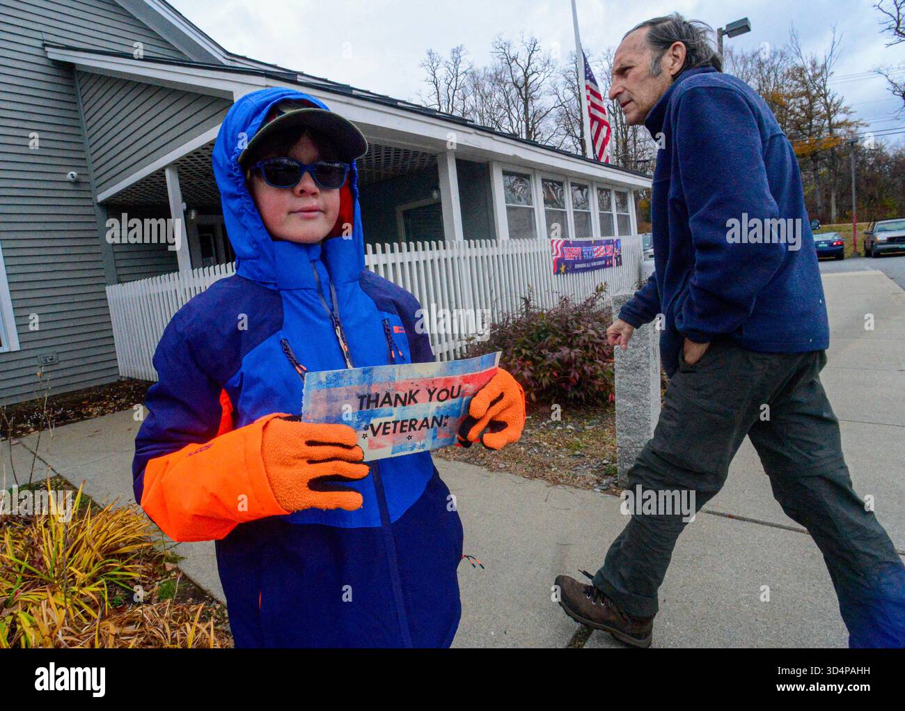 Xander Niland-Gill, 9, and a member of Cub Scout Pack 447, greets ...