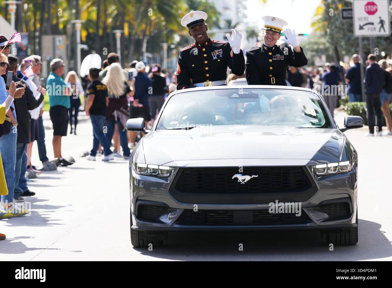 Members of the U.S. military wave during a Veterans Day parade along ...