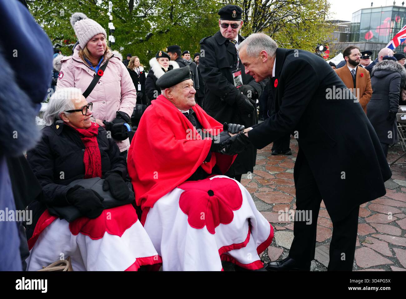 Prime Minister Mark Carney shakes hands with Second World War veteran John Preece, 99, following ...