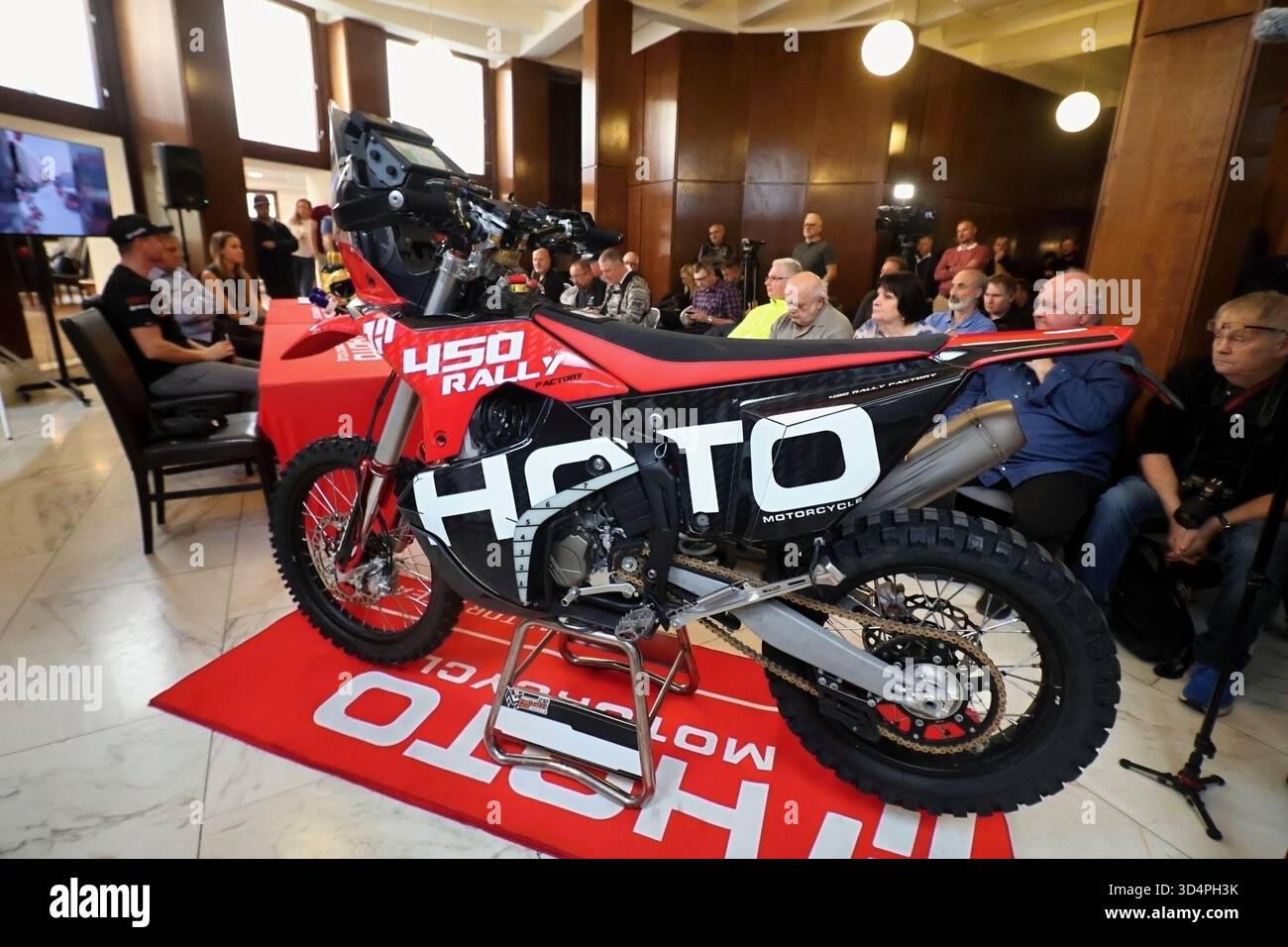 Racer Martin Michek speaks at a press conference where his new factory ...