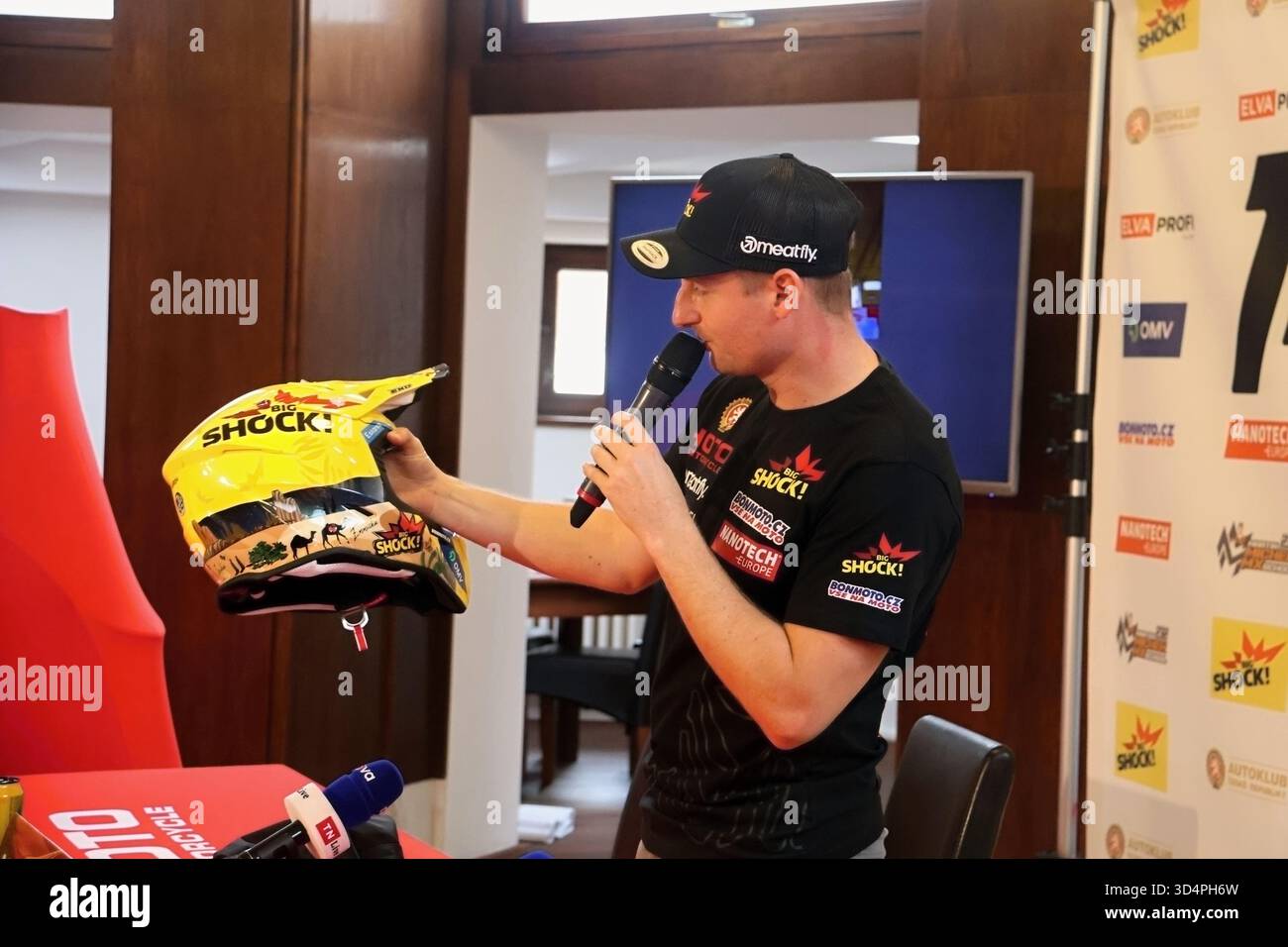 Racer Martin Michek speaks at a press conference where his new factory ...