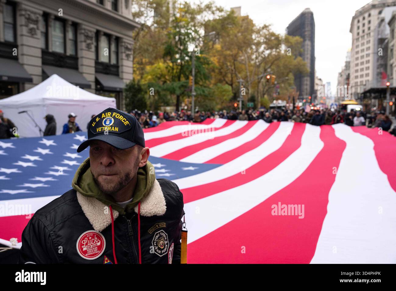 A U.S. Air Force veteran holds an American flag during the Veterans Day ...