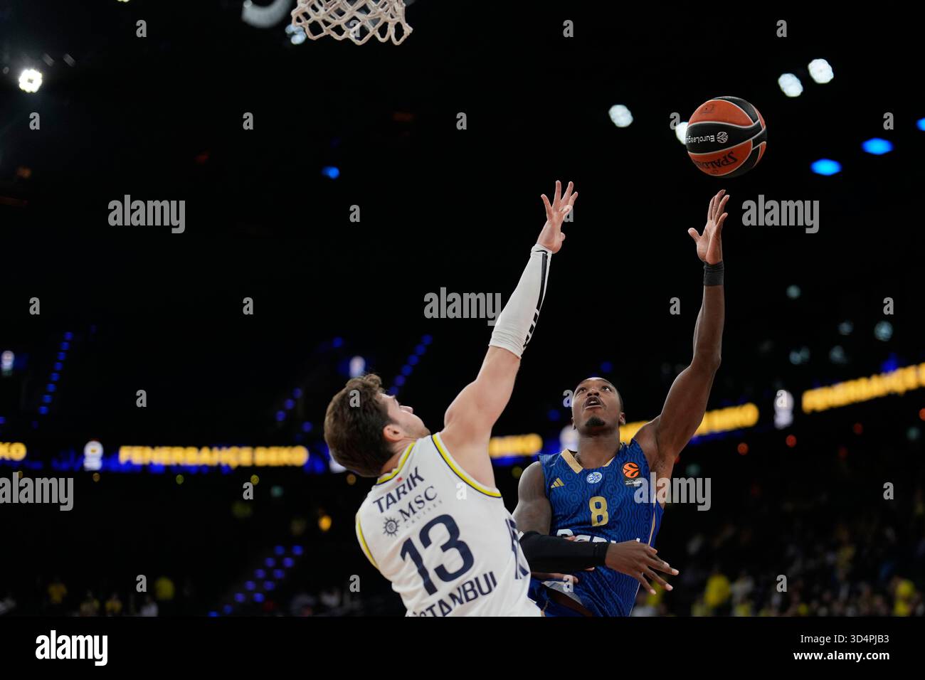 Fenerbahce's Tarik Biberovic, left, challenges Maccabi's Lonnie Walker ...