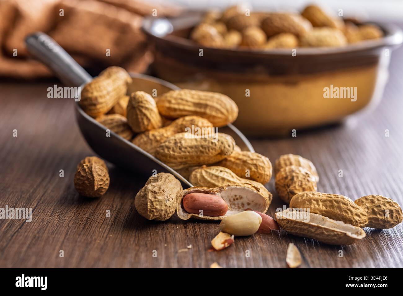 Peanuts in shell. Groundnuts in scoop on a wooden table Stock Photo - Alamy