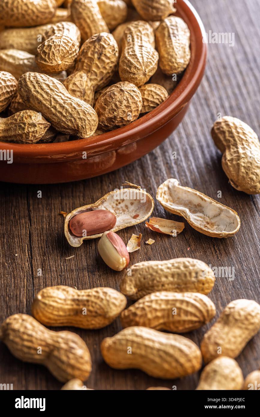 Peanuts in shell. Groundnuts on a wooden table Stock Photo - Alamy