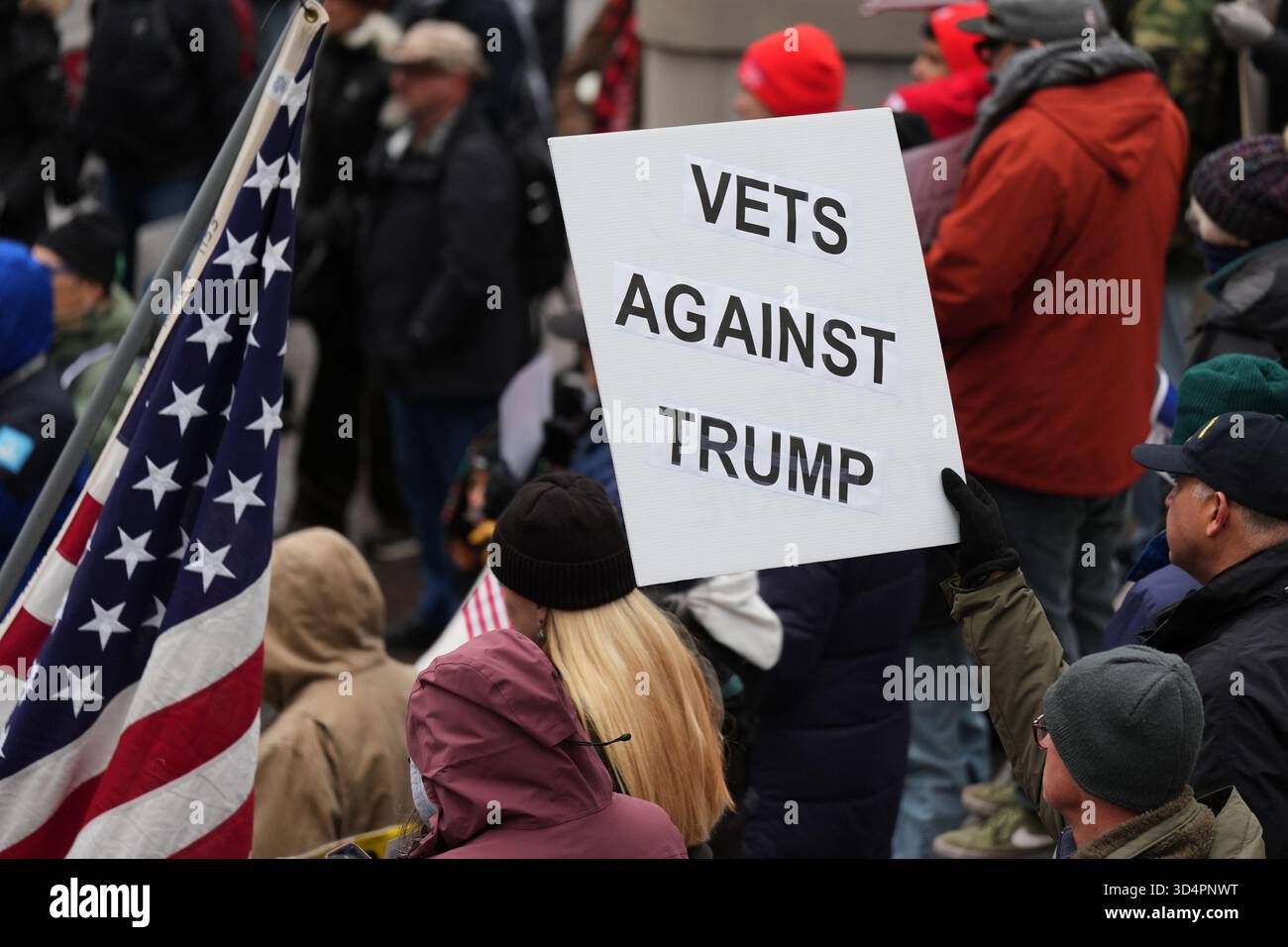 A veteran holds a sign during a Veterans Day protest in Chicago ...