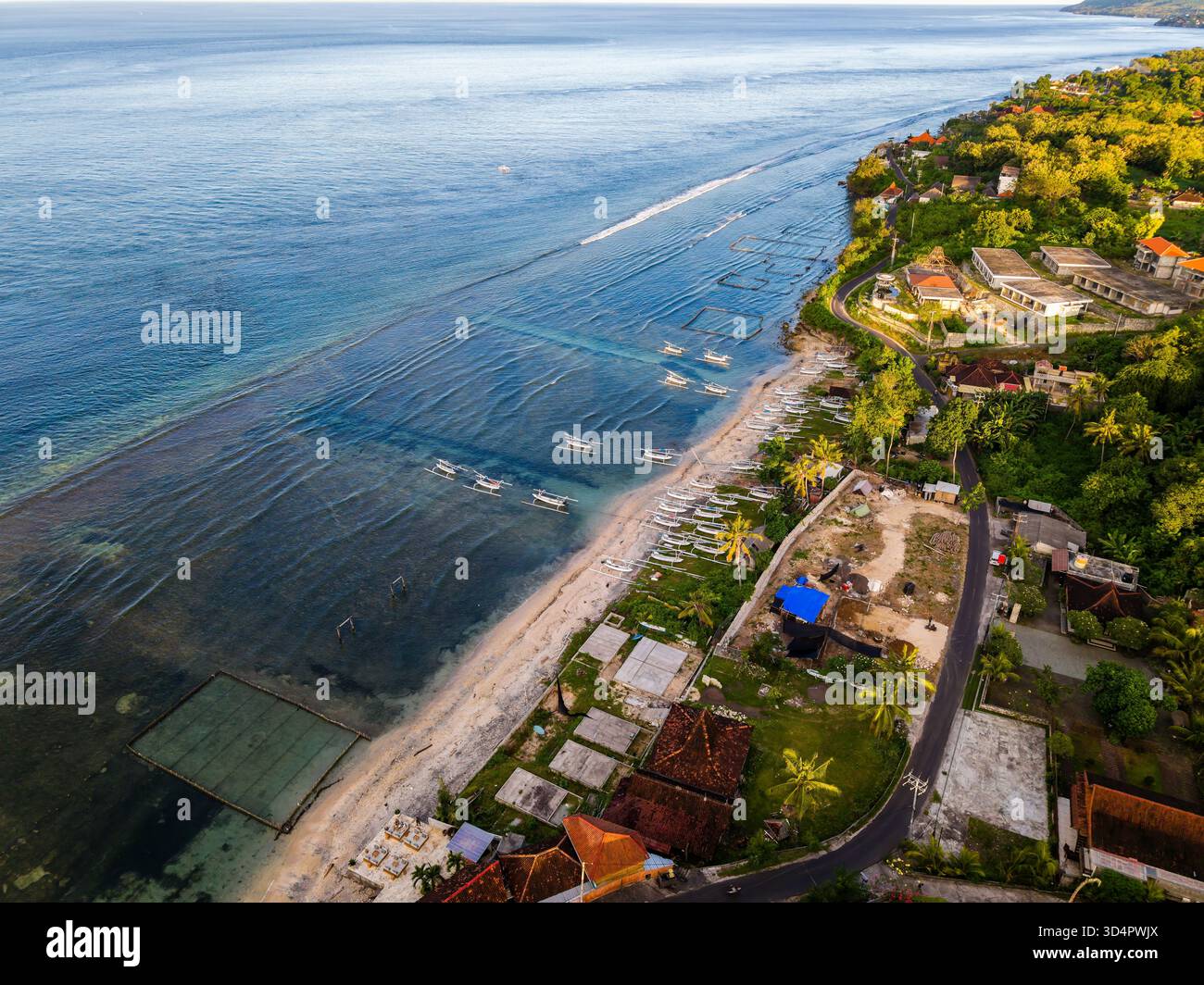 Traditional jukung fishing boats on a beach in Nusa Penida with seaweed ...