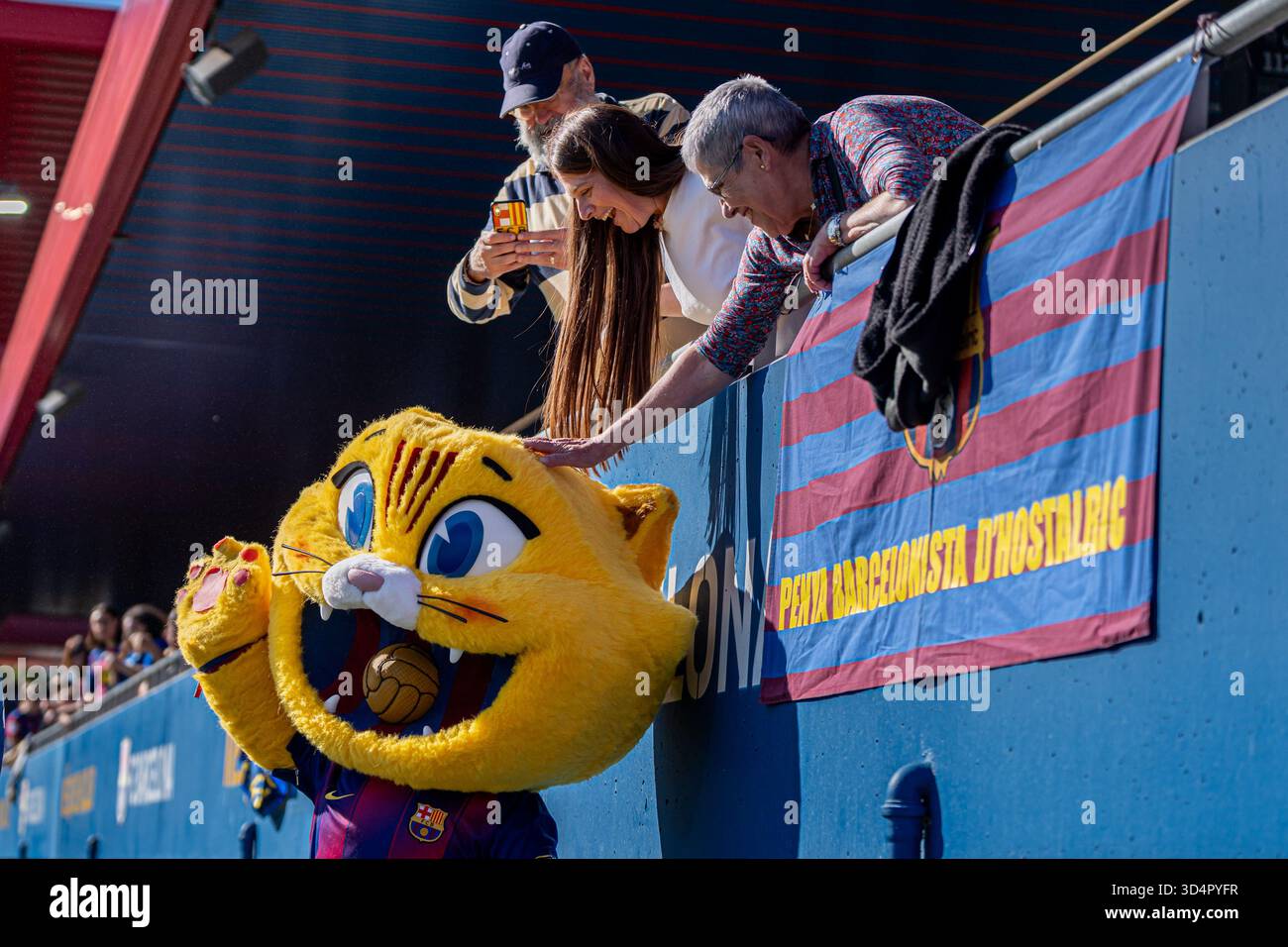 Barcelona fans getting a picture with Barcelona's mascot Cat on the ...