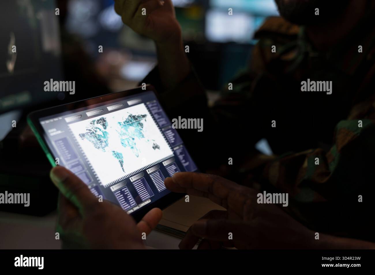 Military officer using tablet device to deploy electronic warfare tools ...