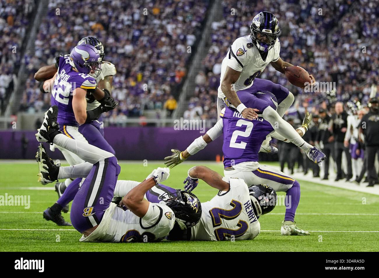 Baltimore Ravens quarterback Lamar Jackson (8) hurdles over Minnesota ...