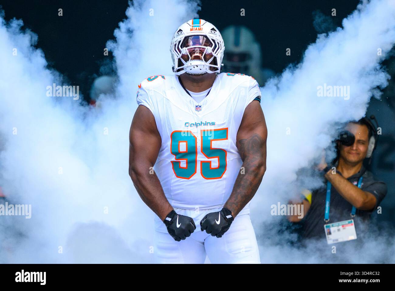 Miami Dolphins defensive tackle Benito Jones (95) yells as he runs onto ...