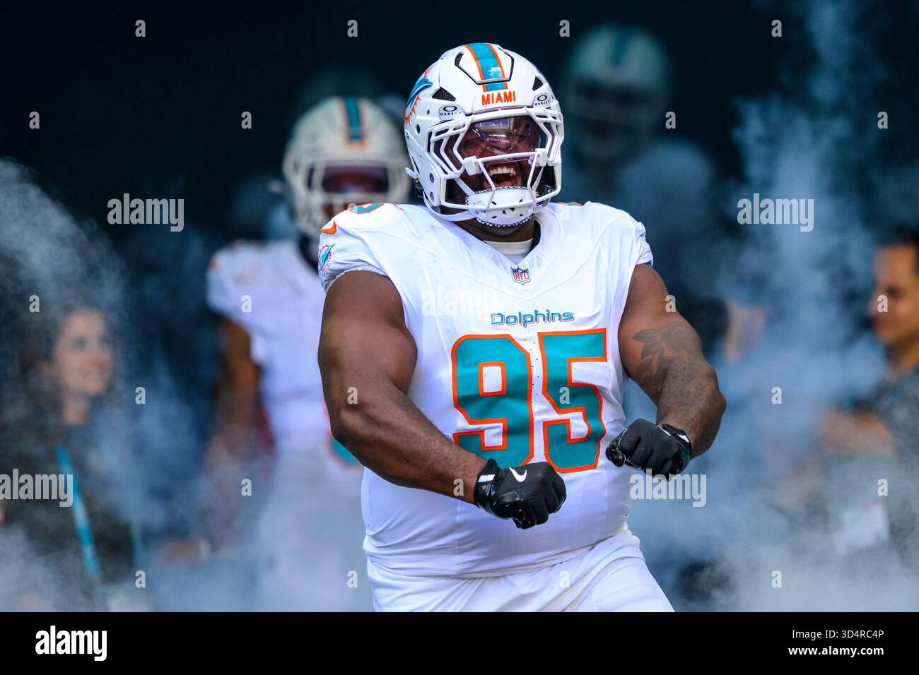 Miami Dolphins defensive tackle Benito Jones (95) yells as he runs onto ...