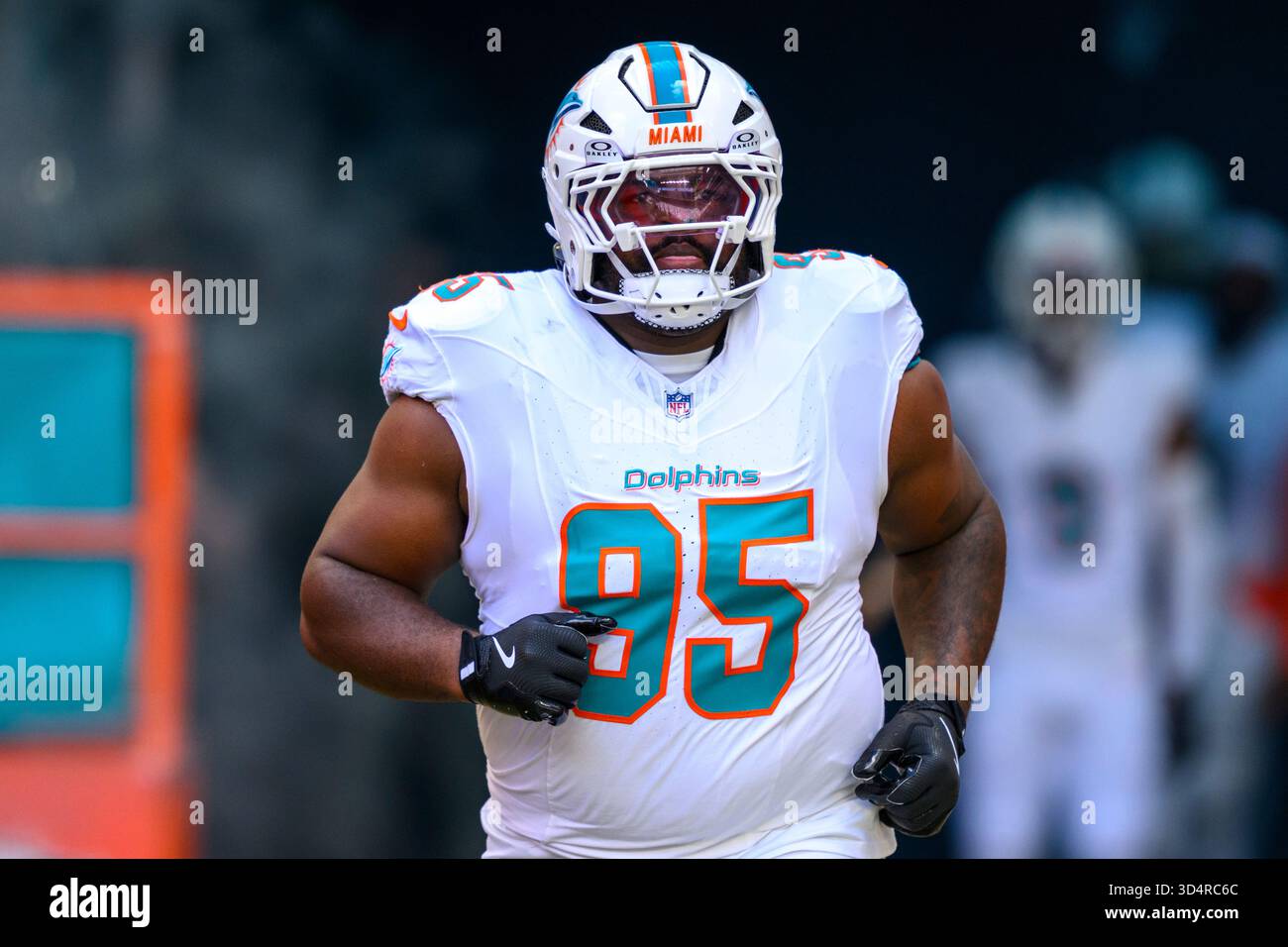 Miami Dolphins defensive tackle Benito Jones (95) runs onto the field ...