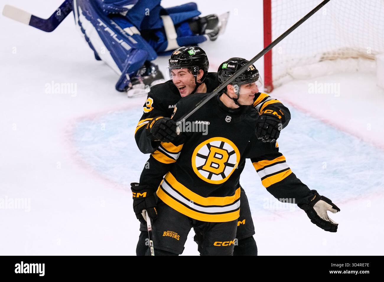 Boston Bruins forward Alex Steeves, right, celebrates after his goal ...