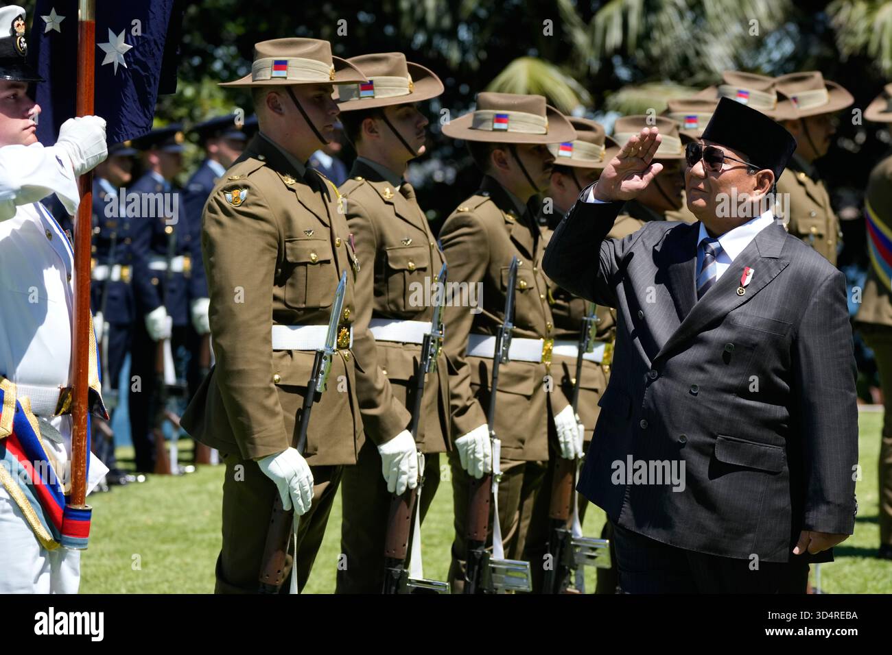 Indonesia's President Prabowo Subianto, right, salutes as he inspects ...
