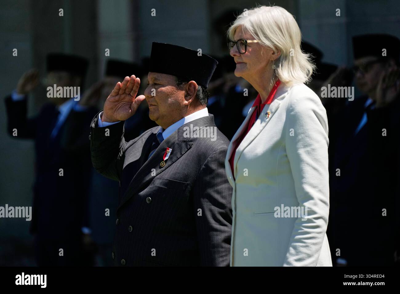 Indonesia's President Prabowo Subianto, left, salutes as he stands with ...