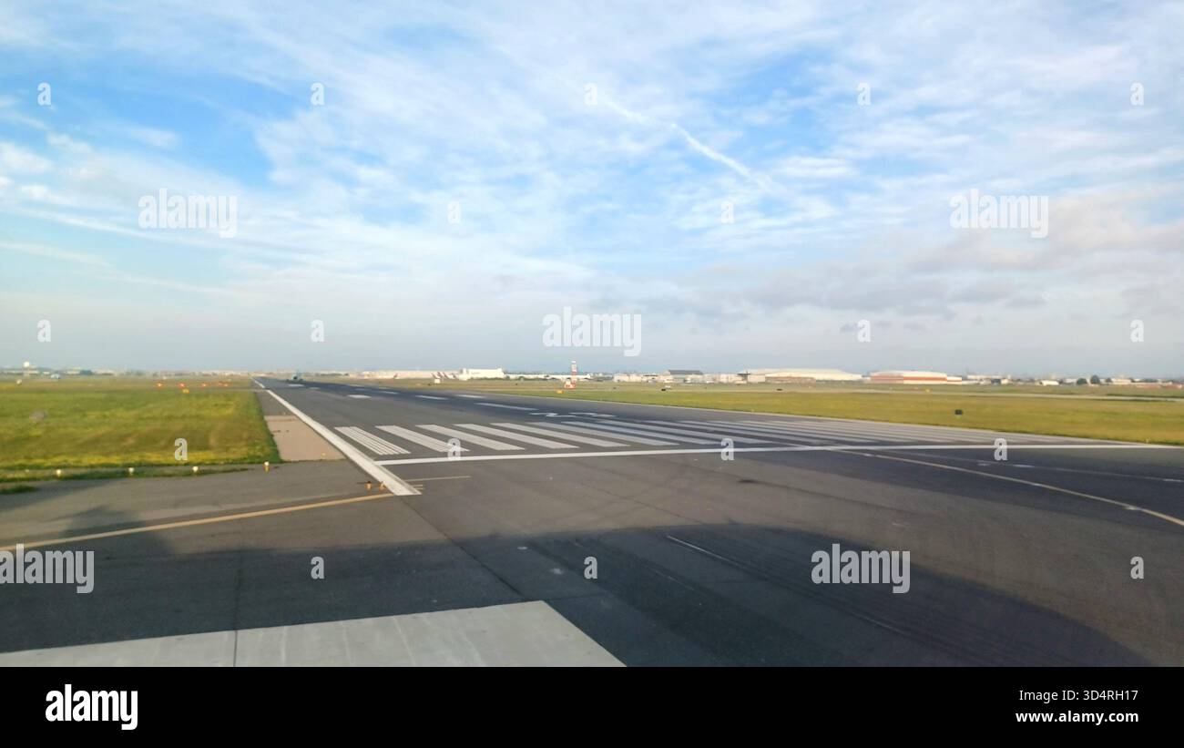 Dallas, TX, USA - July 9, 2025 - A wide, empty airport runway stretches ...
