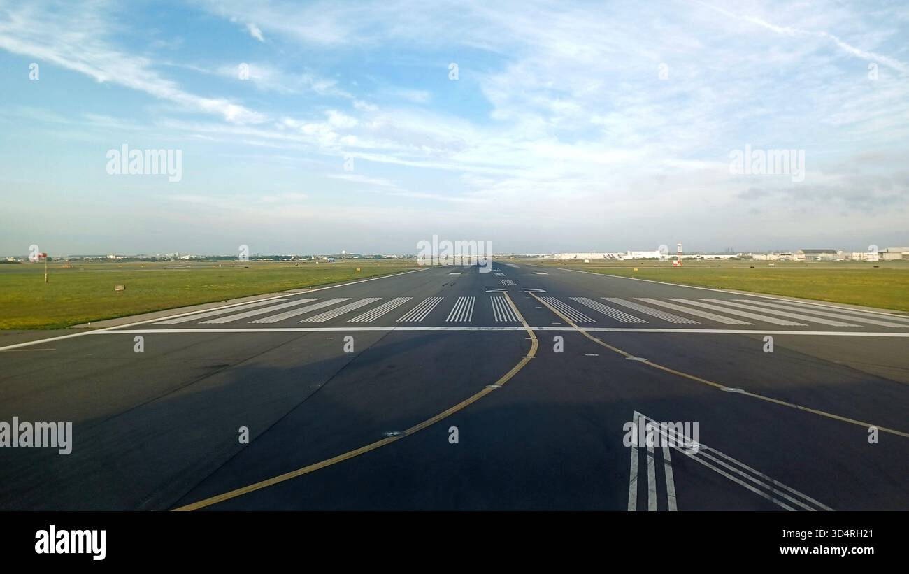 Dallas, TX, USA - July 9, 2025 - A wide, empty airport runway stretches ...