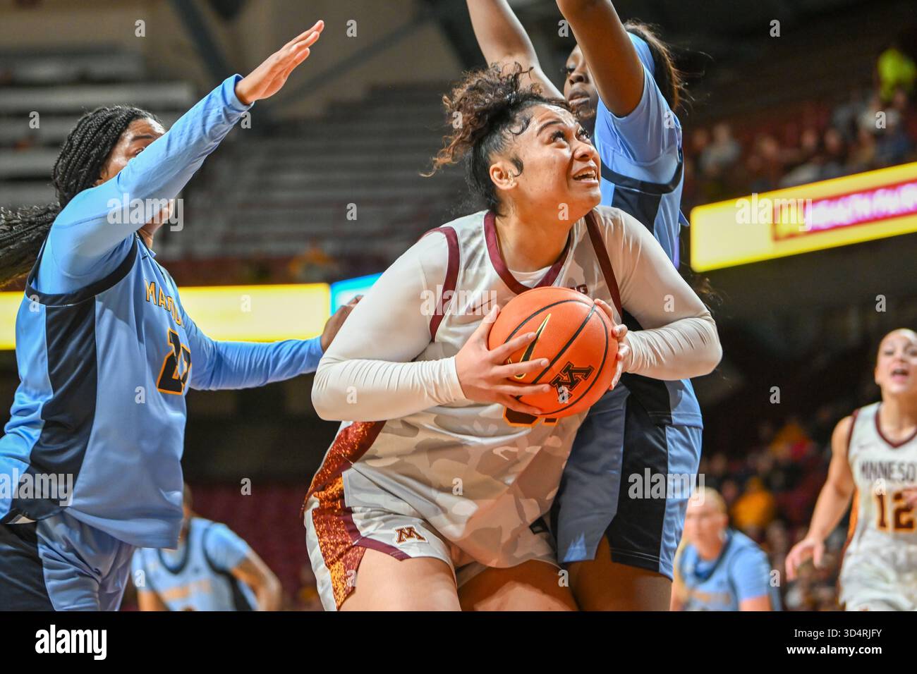 Minnesota forward Finau Tonga, center, drives to the basket between ...