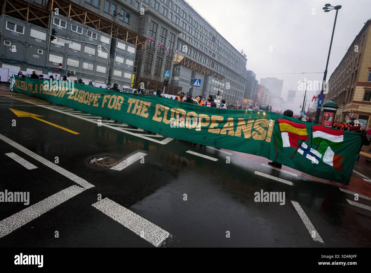 A large banner is held near the front of the march, which reads "Poland ...