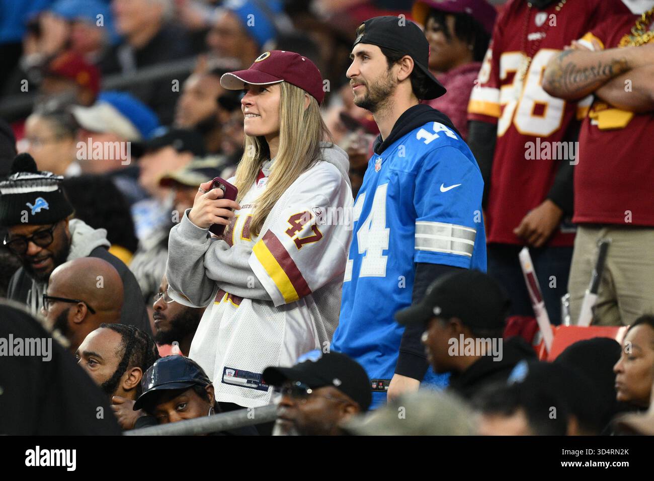 Spectators react during the first half of an NFL football game between ...