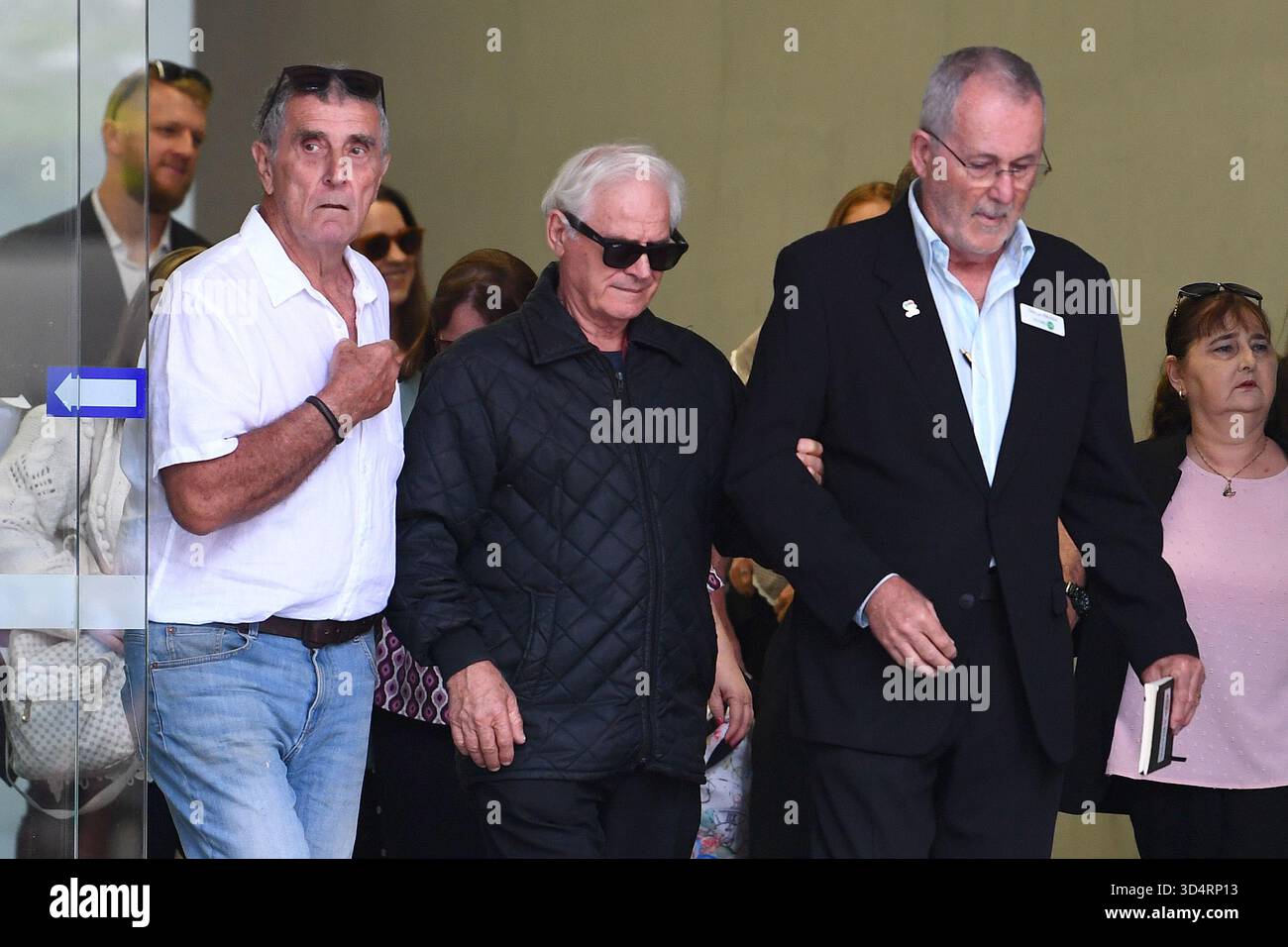 Victor White (middle) husband of Vyleen White, leaves the Brisbane ...