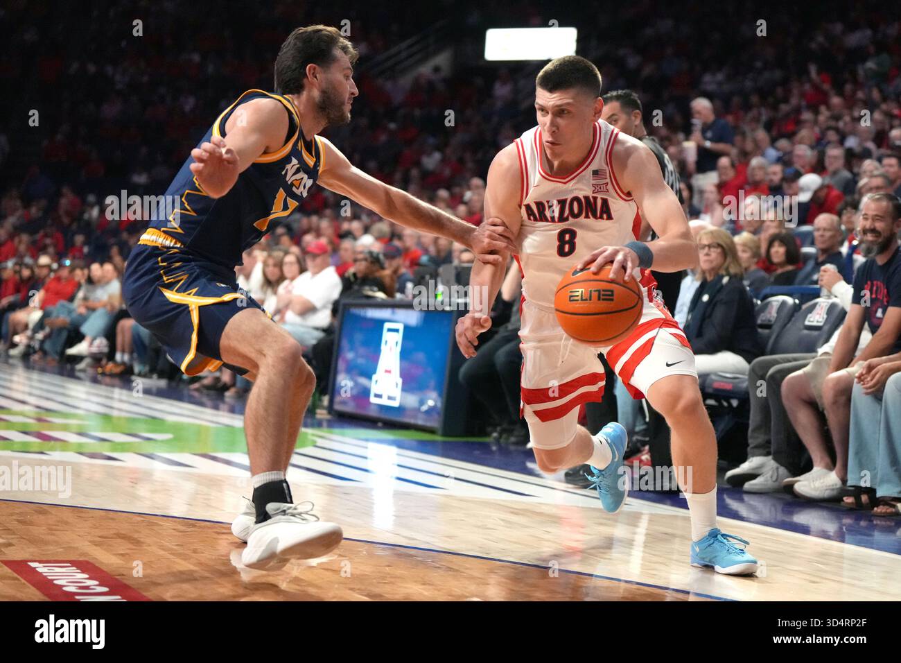 Arizona forward Ivan Kharchenkov (8) drives on Northern Arizona guard ...
