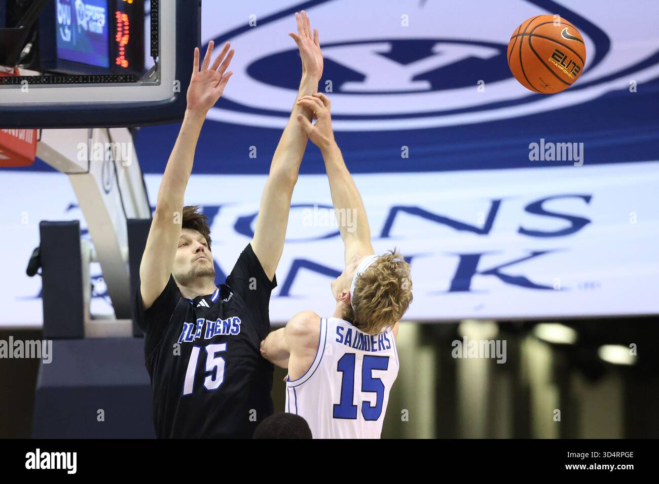 BYU guard Richie Saunders has his shot blocked by Delaware forward ...
