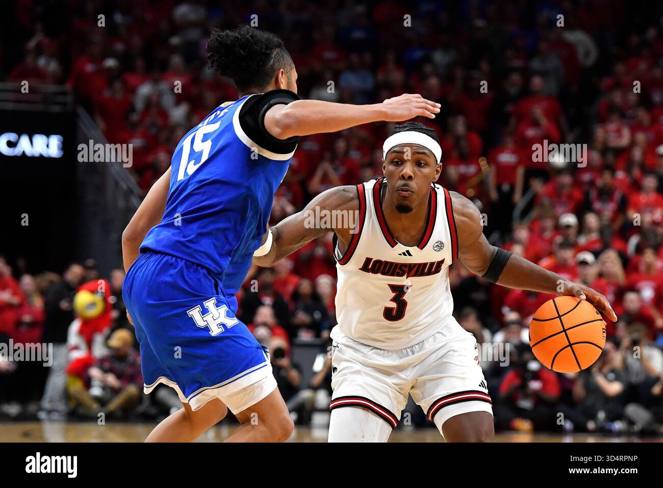 Louisville guard Ryan Conwell (3) attempts to drive past Kentucky guard ...