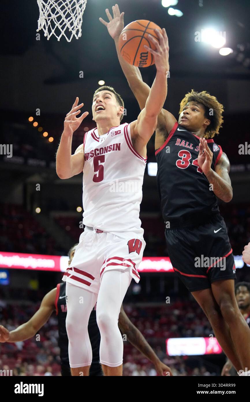 Wisconsin guard Jack Janicki (5) scores against Ball State forward ...