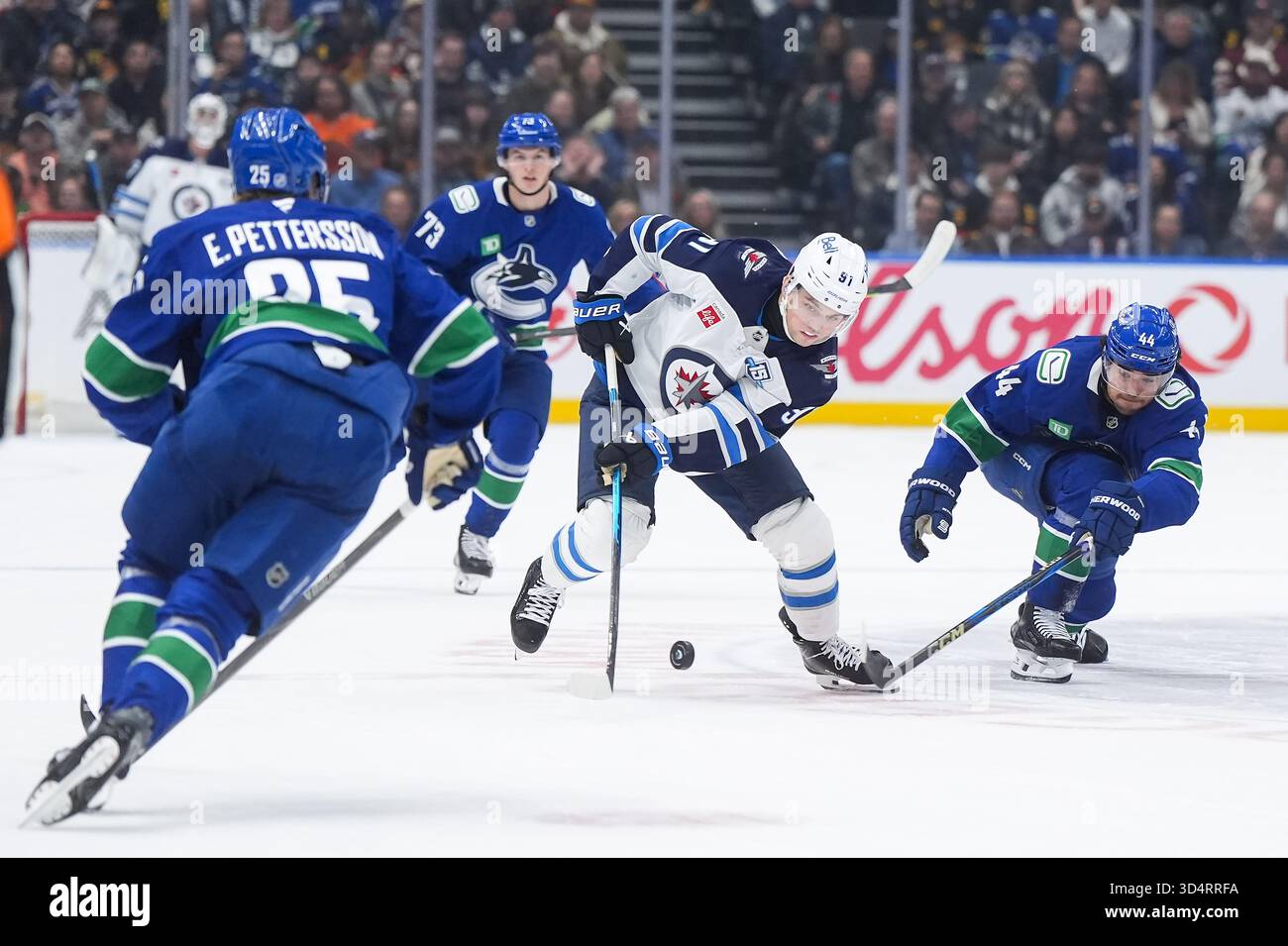 Winnipeg Jets' Cole Perfetti (91) and Vancouver Canucks' Kiefer ...