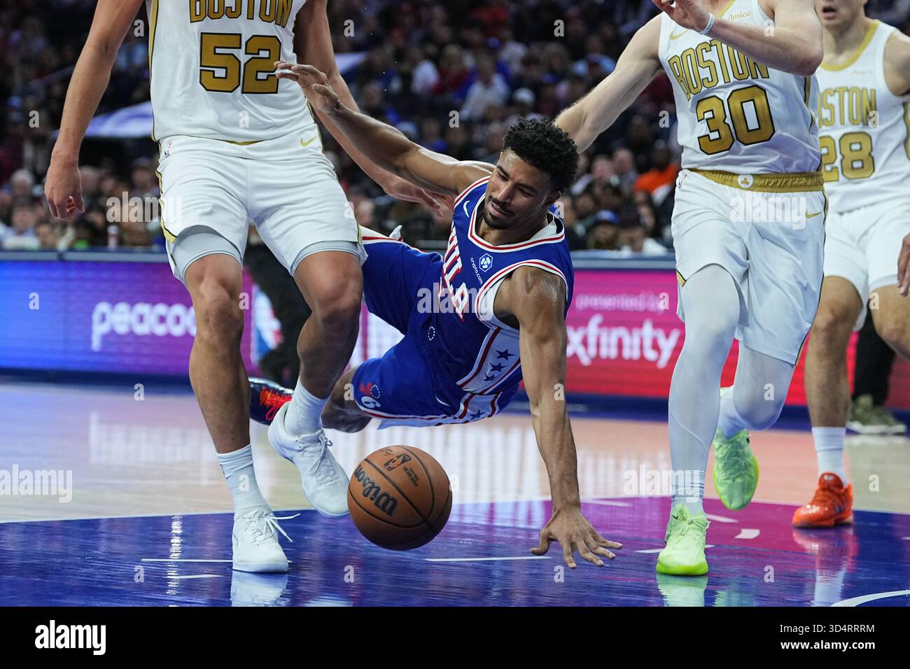 Philadelphia 76ers' Quentin Grimes, center, goes down after being ...