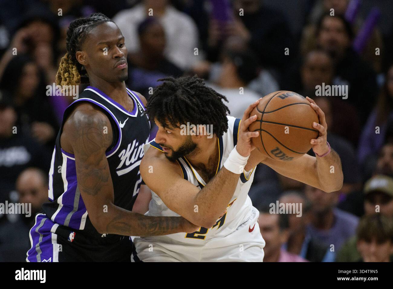 Sacramento Kings guard Keon Ellis, left, guards Denver Nuggets guard ...