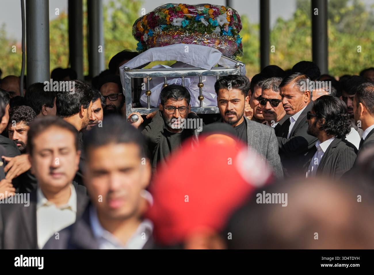 Mourners carry the coffin of lawyer Zubair Aslam Ghumman, who was ...