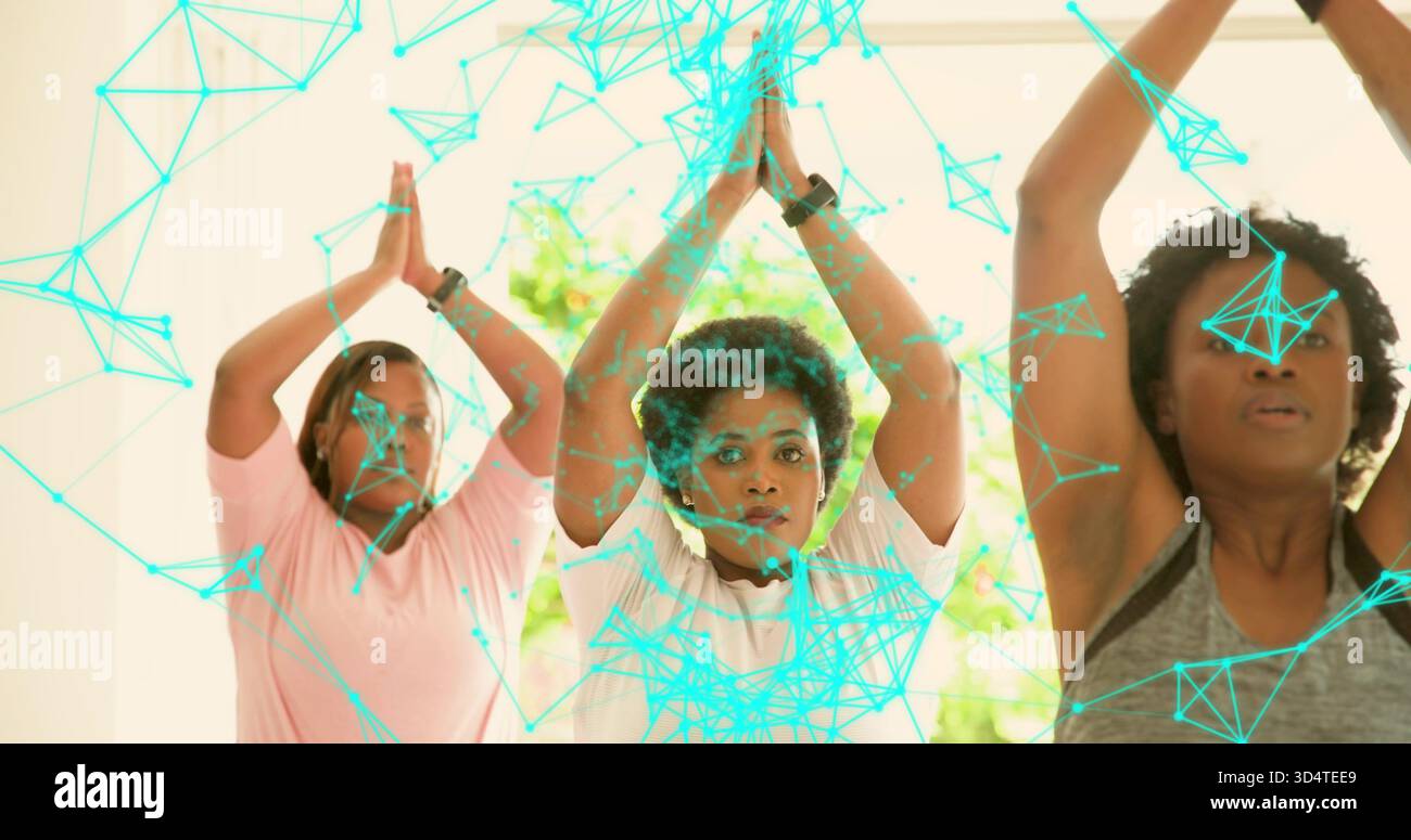Performing three midlife women in activewear raising palms above heads ...
