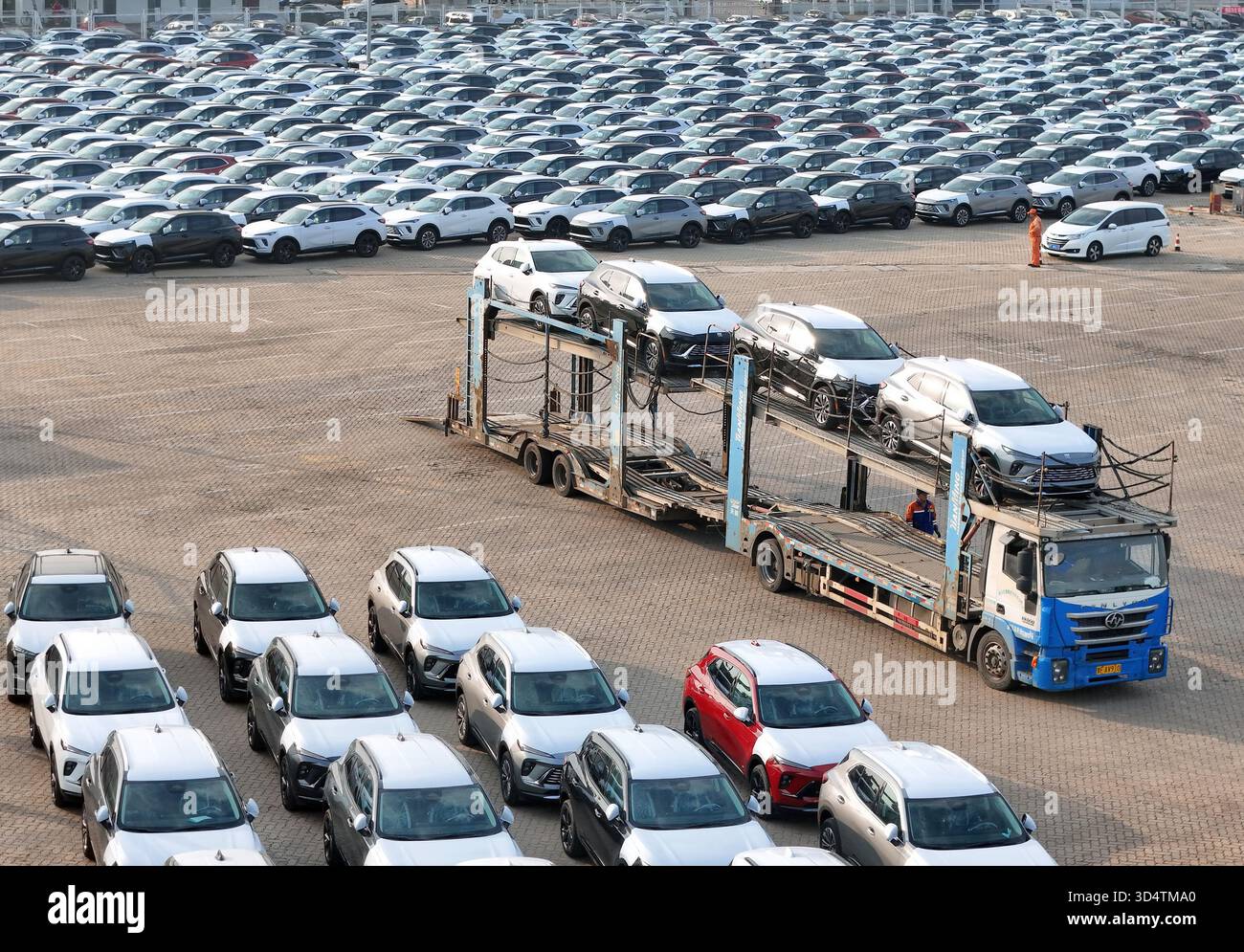 Chinese-made vehicles are gathered at Yantai Port waiting to be loaded ...