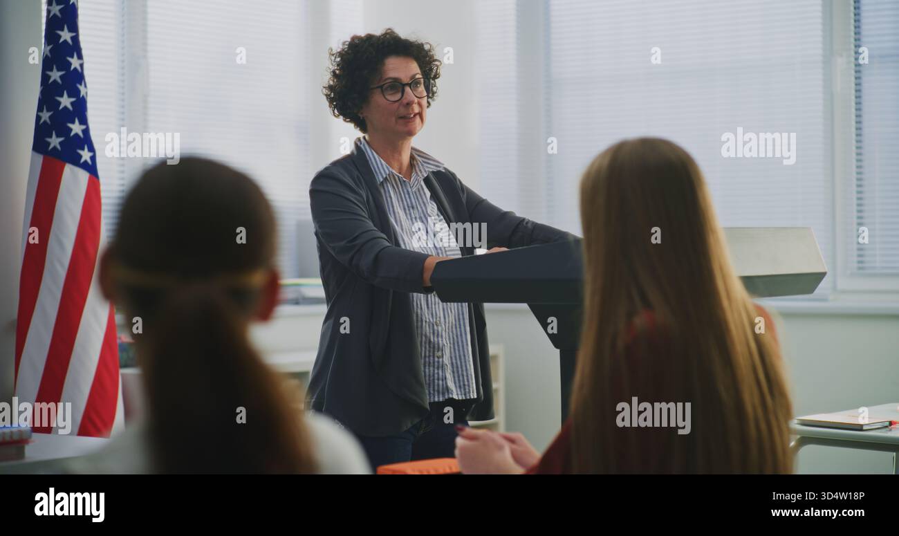 American Teacher Stands Podium Beside US Flag, Engaging Students In ...