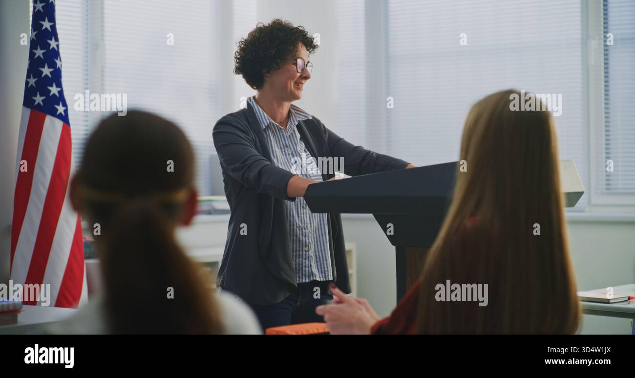American Teacher Stands Podium Beside US Flag, Engaging Students In ...