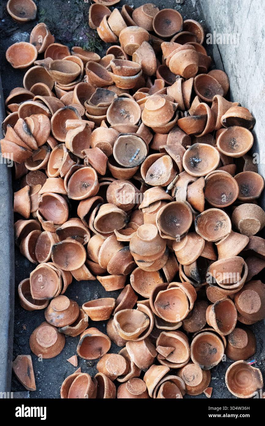 pile of clay Tea cups discarded and thrown away at the side of the road ...