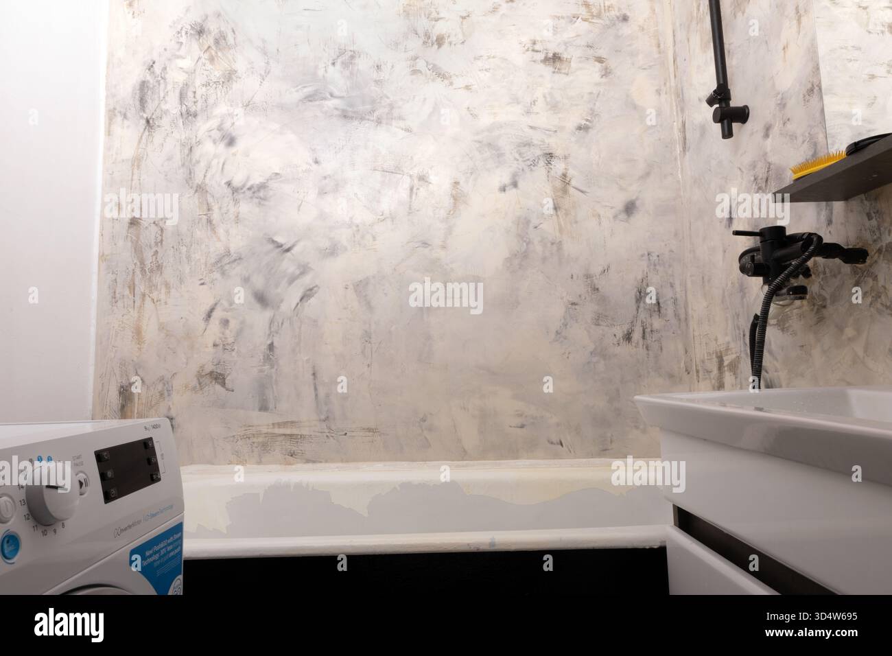 Minimalist bathroom with washing machine, white sink, textured wall ...