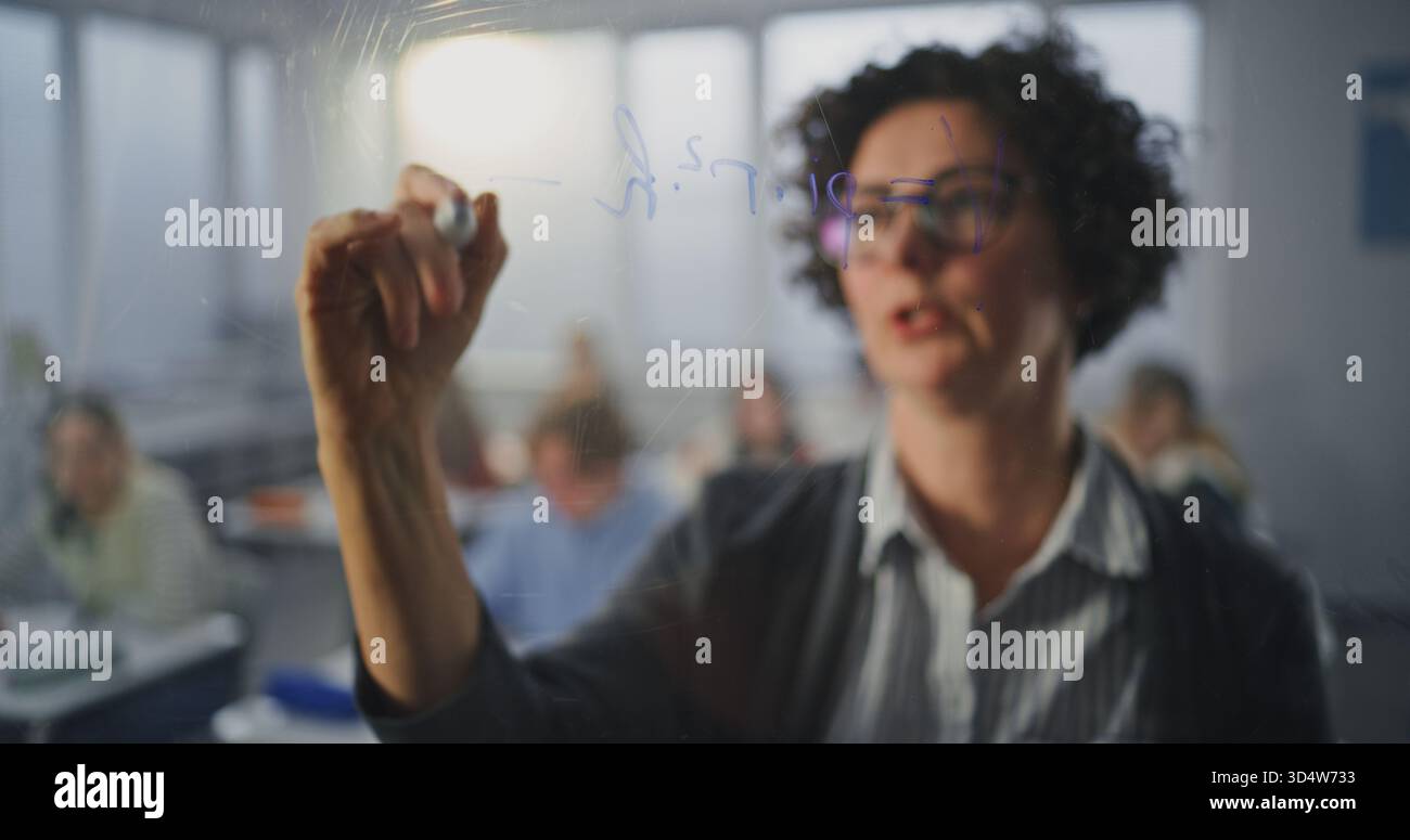 Dynamic Female Teacher With Glasses Writes With Marker Formulas ...