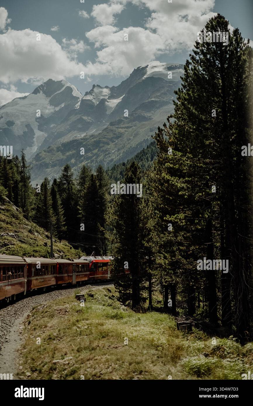 Bernina Express passing Hotel Belvedere at Alp Grüm with scenic glacier ...