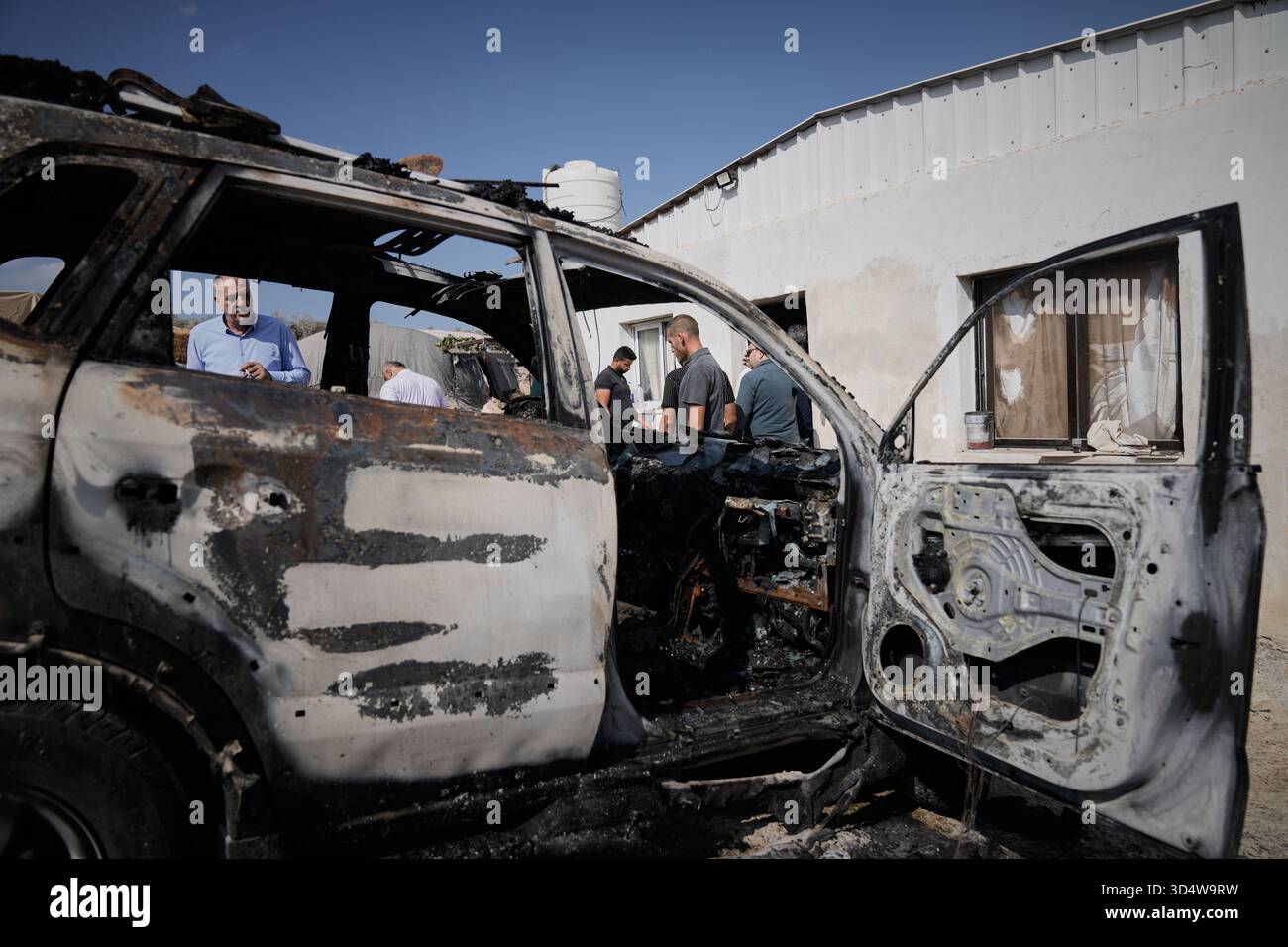 Palestinians survey damage in an industrial zone following an attack by Israeli settlers the ...