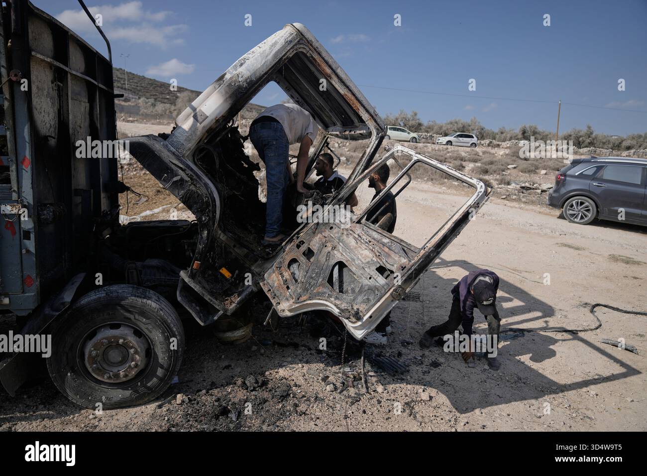 Palestinians survey damage in an industrial zone following an attack by ...