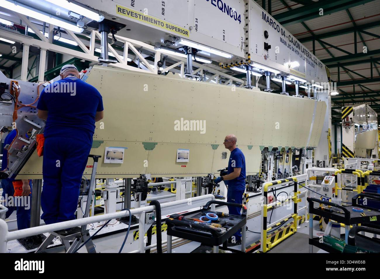 Operators working on the new A350 production line at the Airbus plant ...