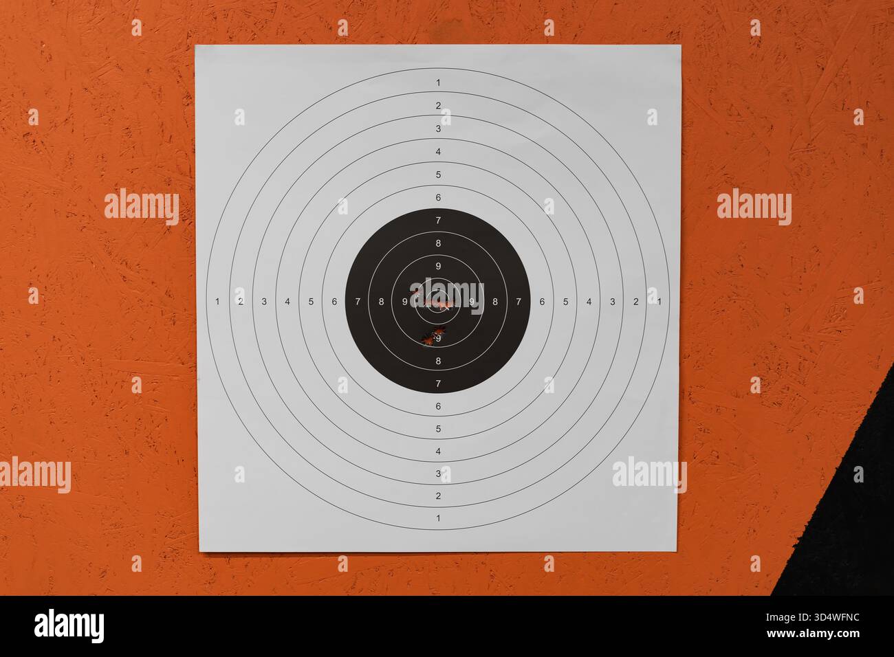 Close-up of a shooting target with a tight grouping of bullet holes in ...