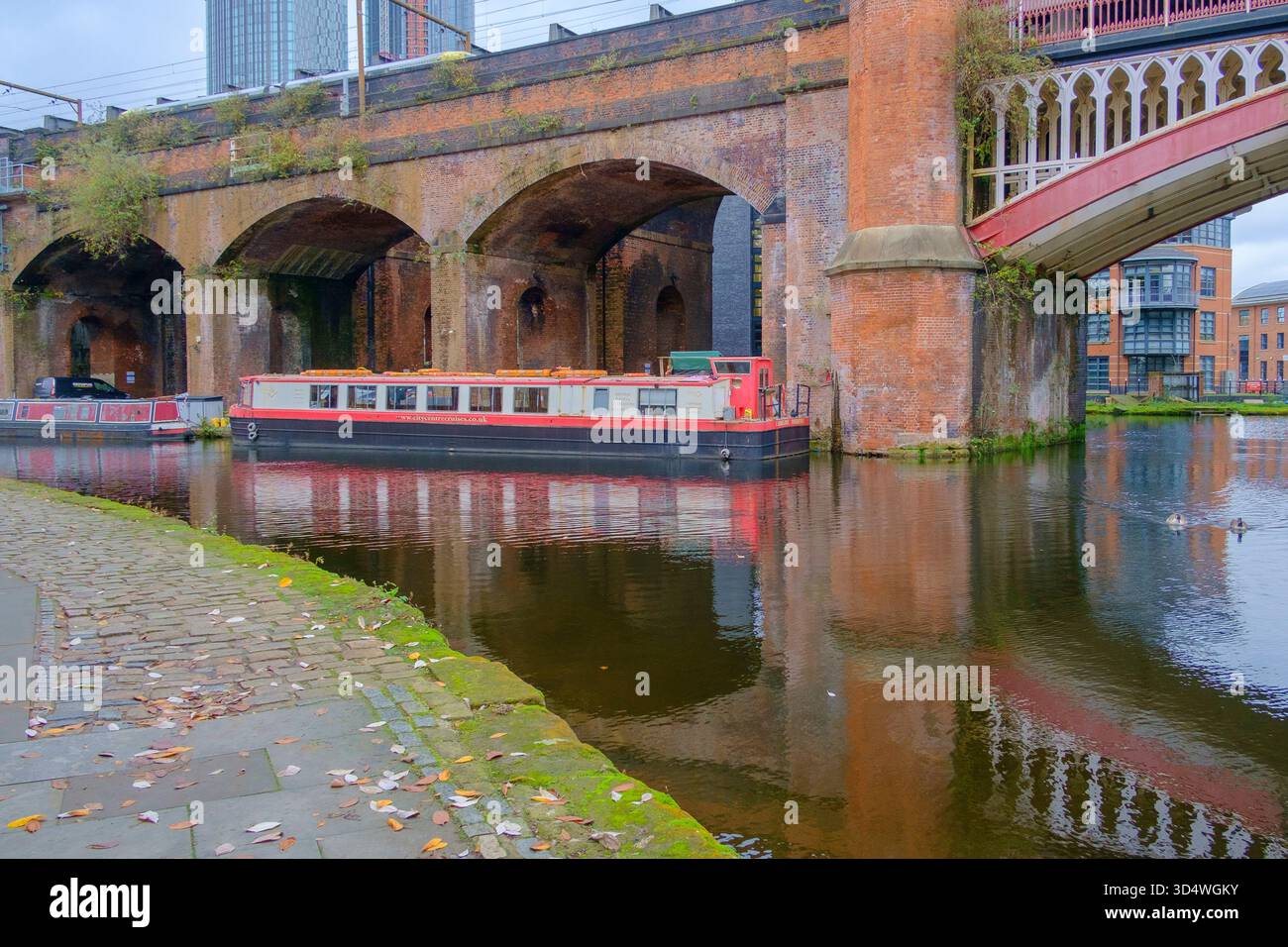Railway viaducts crossing over the Bridgewater canal with a red and ...