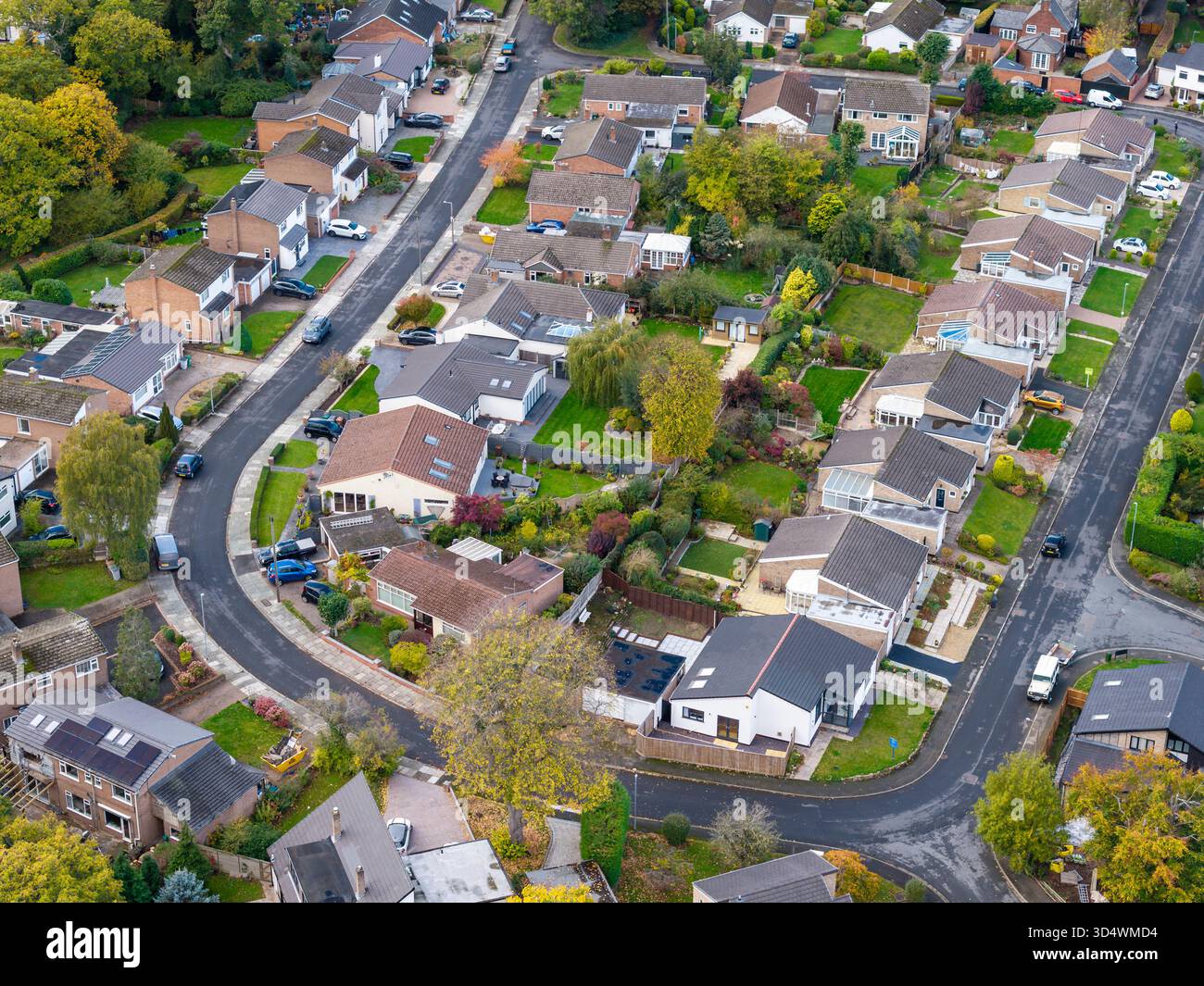 Aerial view shows a residential cul de sac with tree lined houses ...