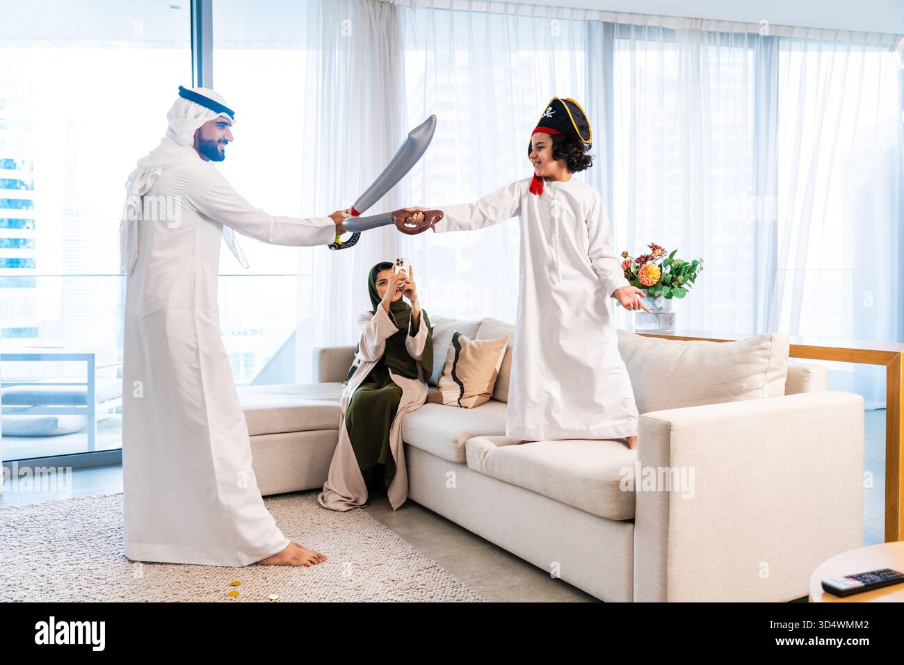 Middle-eastern family wearing traditional emirati clothing spending ...