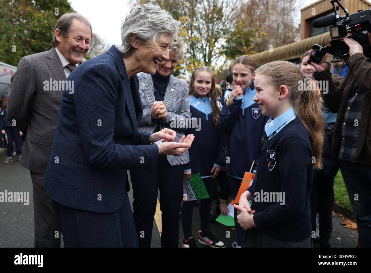 President Catherine Connolly meeting pupils during a visit to Gaelscoil ...